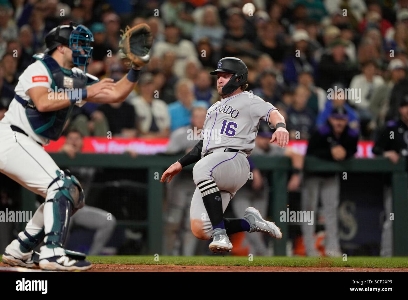 Colorado Rockies' Blaine Crim, right, slides home to score past Seattle ...