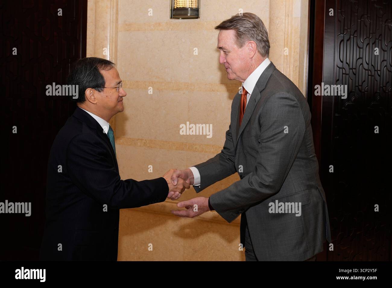 U.S. Ambassador to China David Perdue, right, shakes hands with Beijing ...