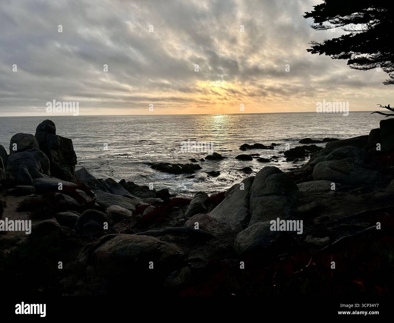 Sunset over rocky coastline hi-res stock photography and images - Alamy