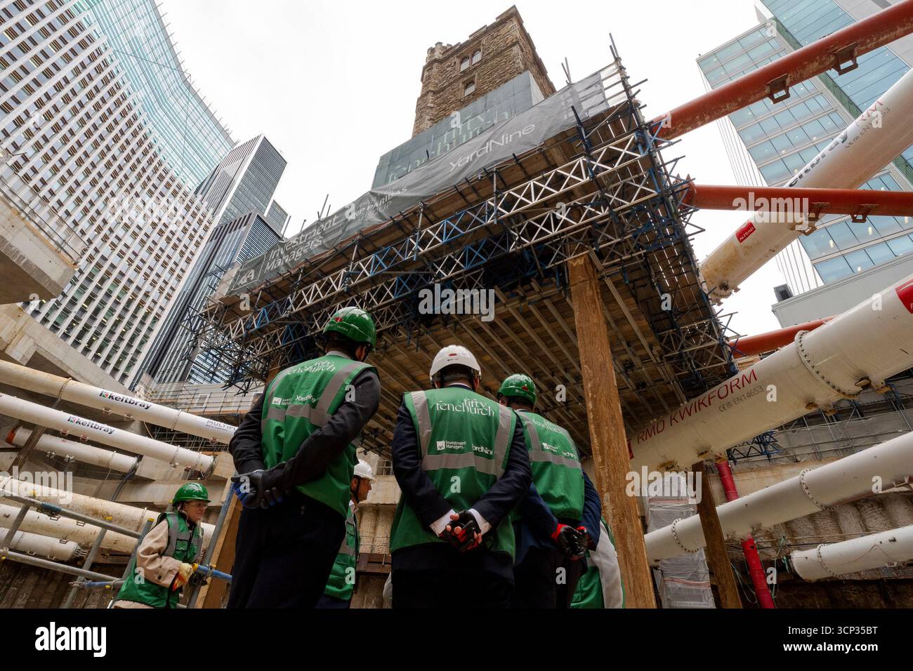People stand beneath the 700-year-old tower of All Hallows Staining ...