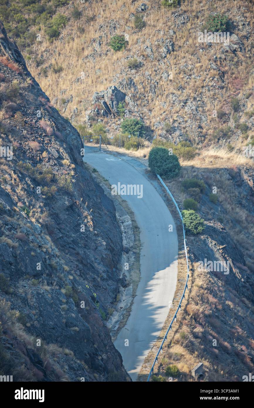 A compacted dirt road that traces natural curves, adapting to the ...