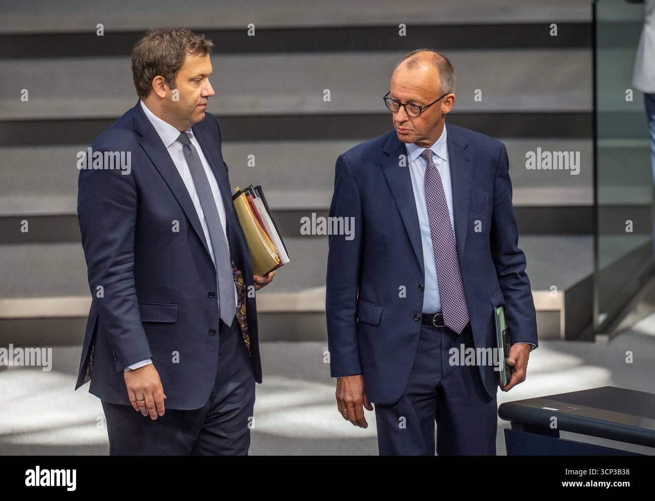 24 September 2025, Berlin: Federal Chancellor Friedrich Merz (CDU, r) joins Lars Klingbeil (SPD ...