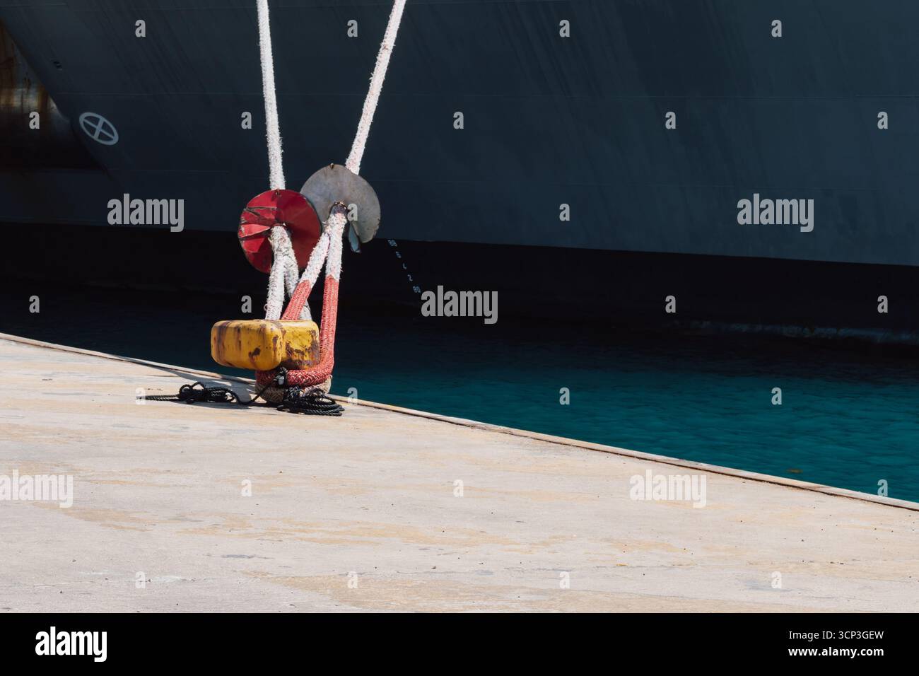 Mooring of a vessel in the port using mooring lines to a bollard on the ...