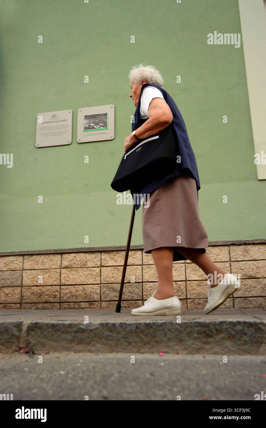 Senior woman with a walking stick, walking aid for mobility Senior ...