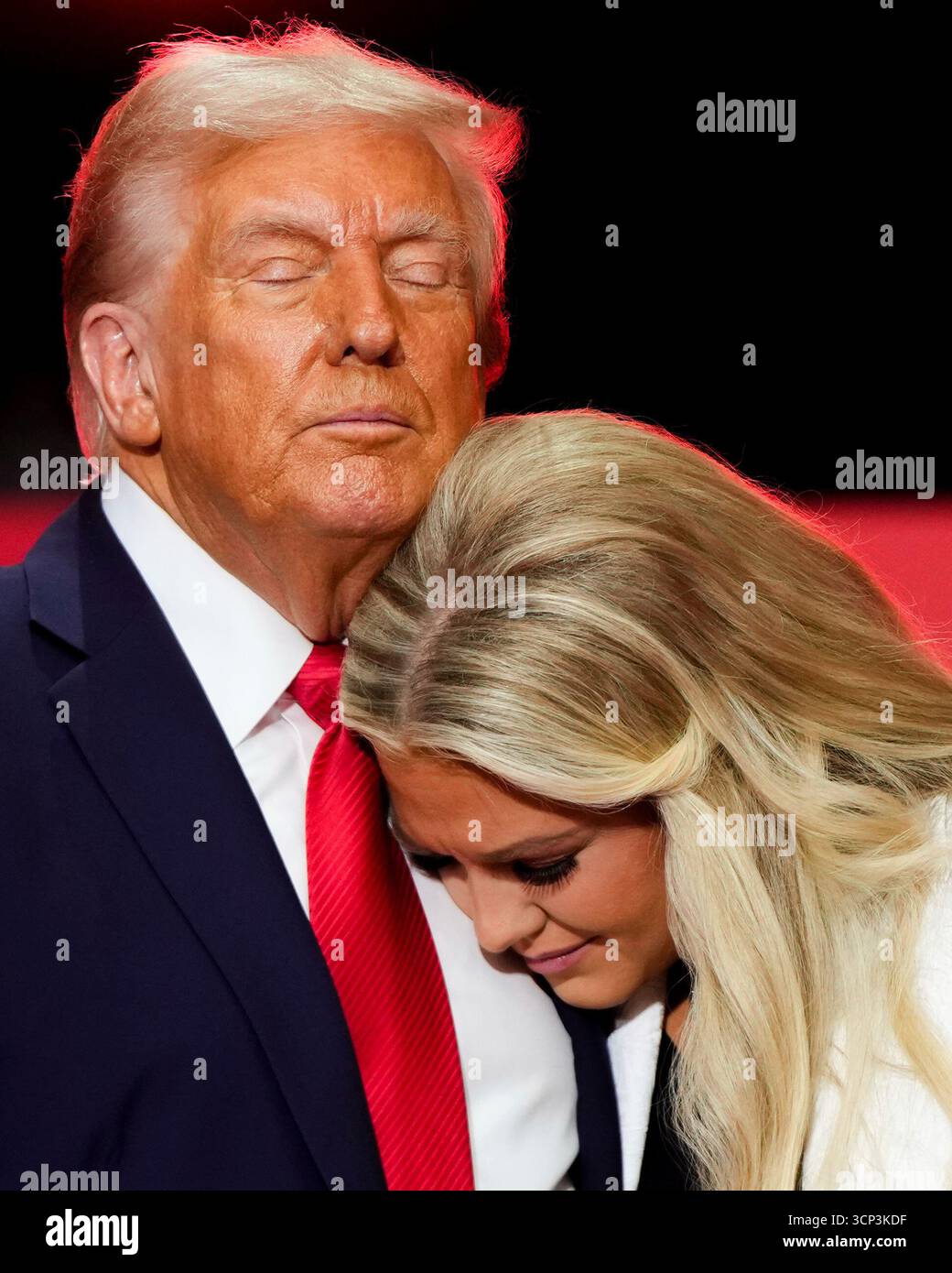 President Donald Trump hugs Erika Kirk at the conclusion of a memorial ...