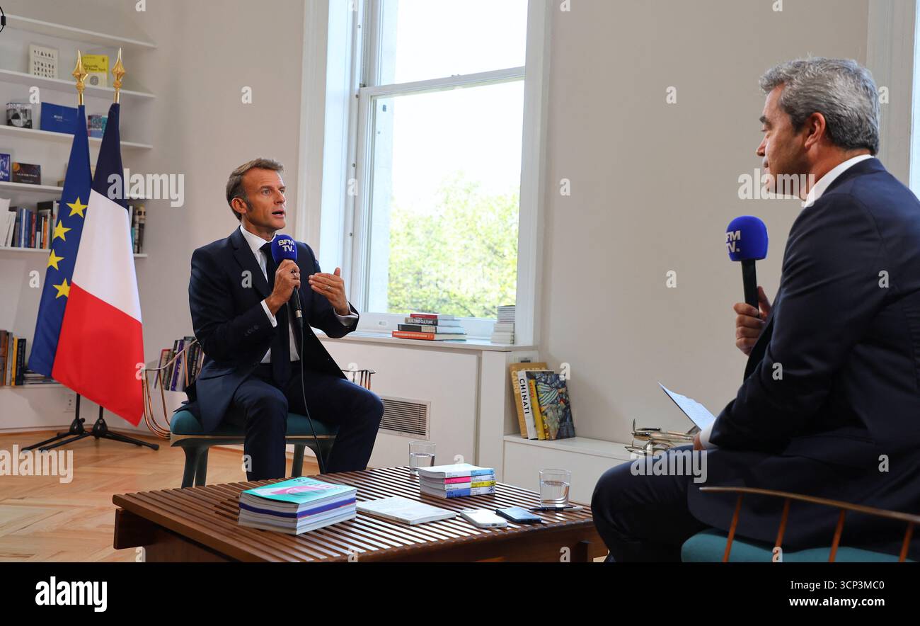 President of France Emmanuel Macron is talking to French TV host ...