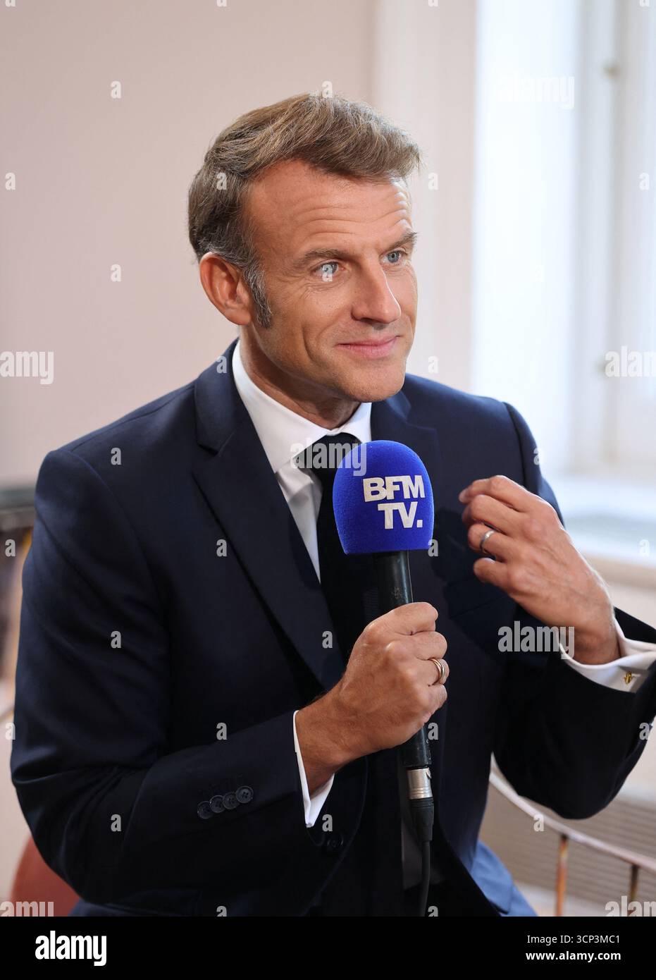 President of France Emmanuel Macron is talking to French TV host ...