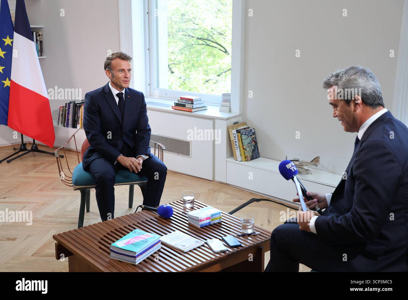 President of France Emmanuel Macron is talking to French TV host ...