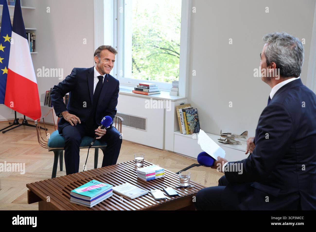 President of France Emmanuel Macron is talking to French TV host ...