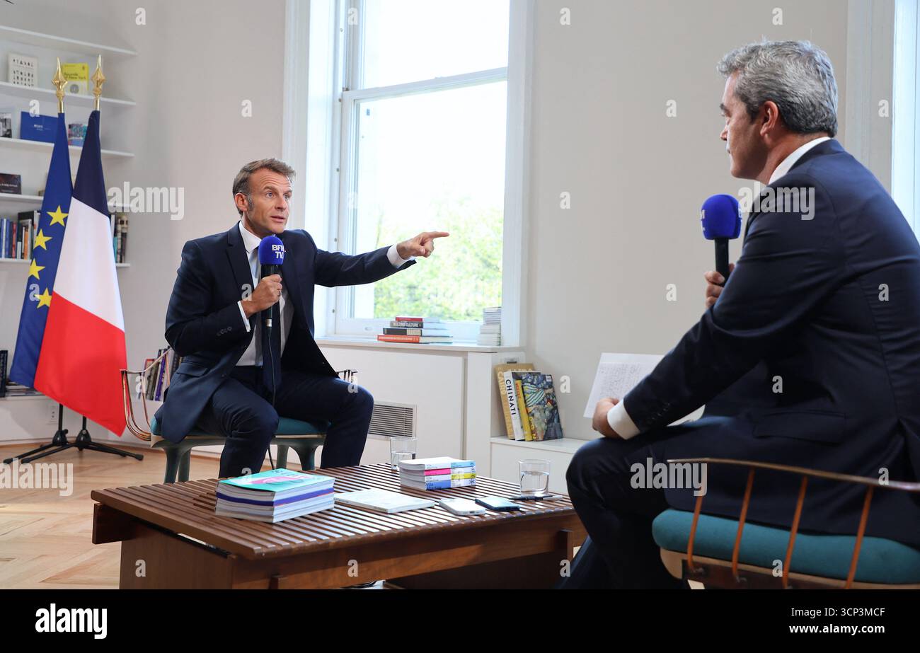 President of France Emmanuel Macron is talking to French TV host ...