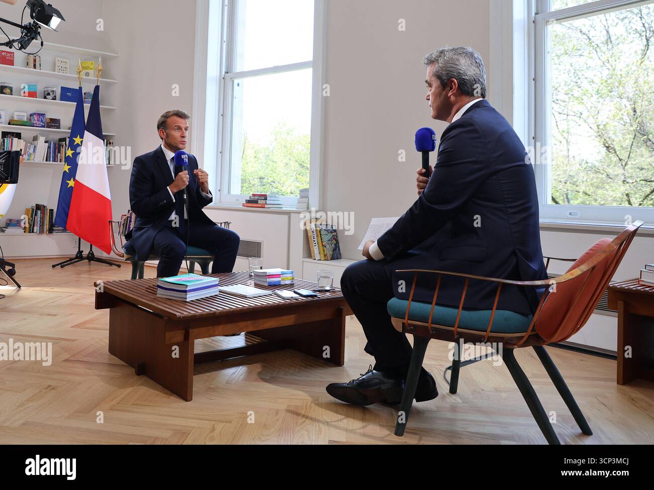 President of France Emmanuel Macron is talking to French TV host ...