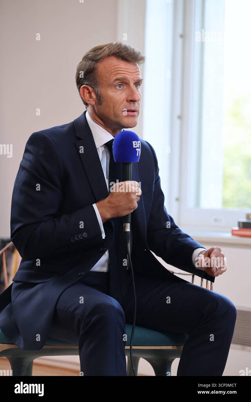 President of France Emmanuel Macron is talking to French TV host ...