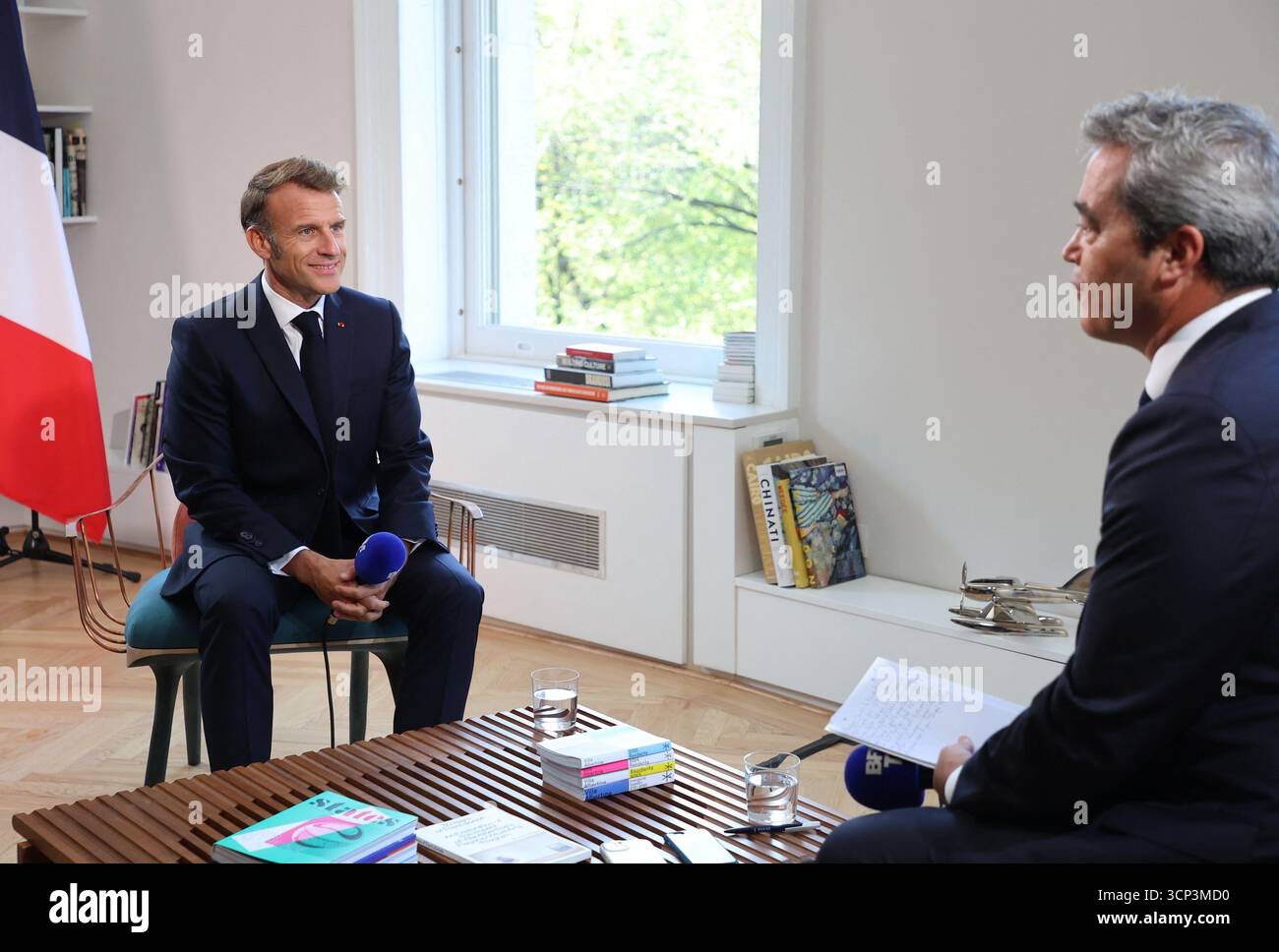 President of France Emmanuel Macron is talking to French TV host ...