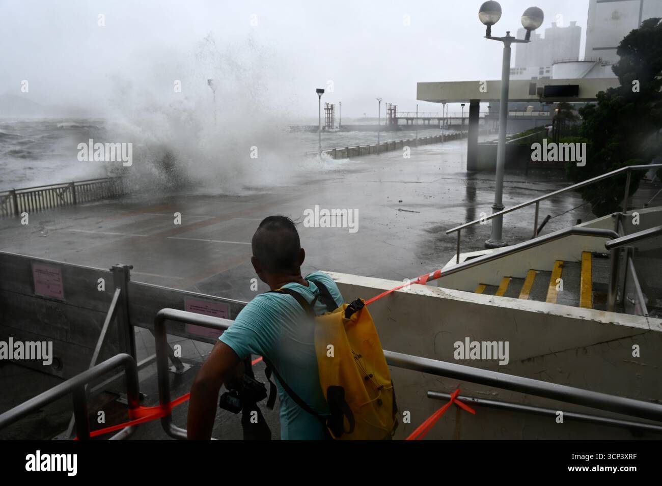 A man watching the strong winds at Heng Fa Chuen as Typhoon Ragasa ...