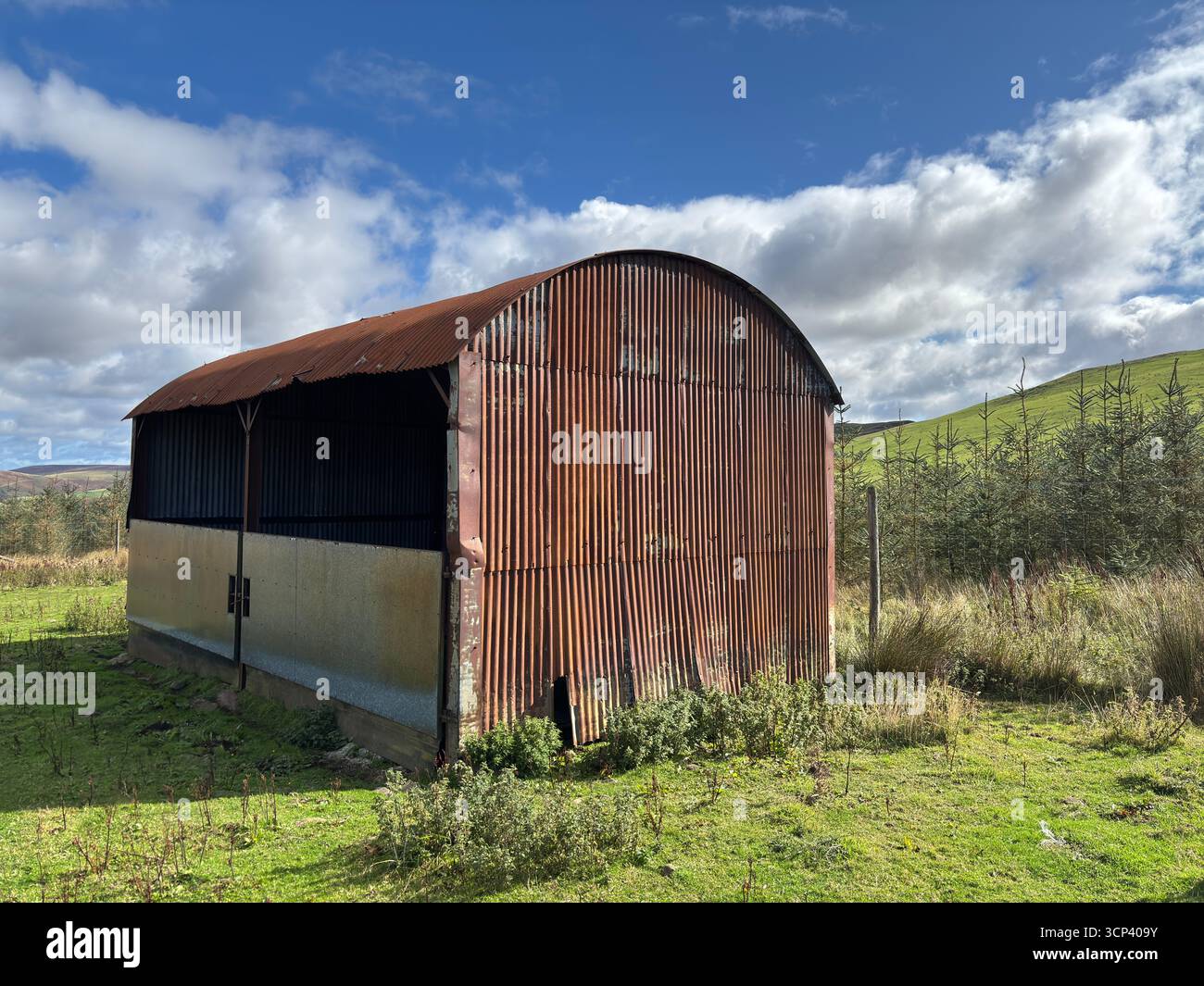 Rusty farm shed in Scottish hills landscape, abandoned structure with ...