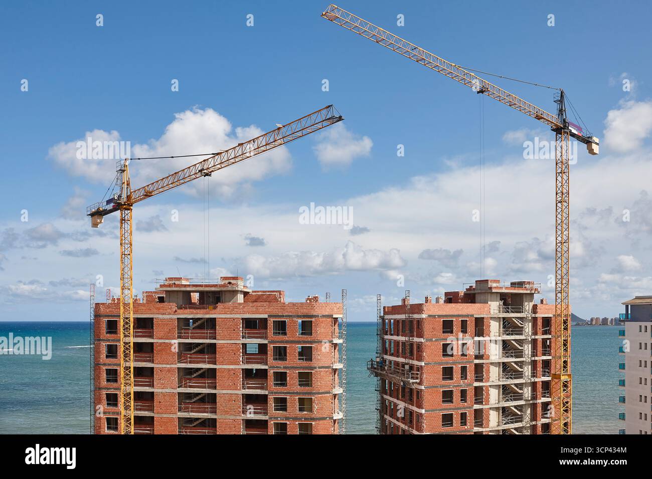 Buildings facades finished with bricks under construction. Construction ...