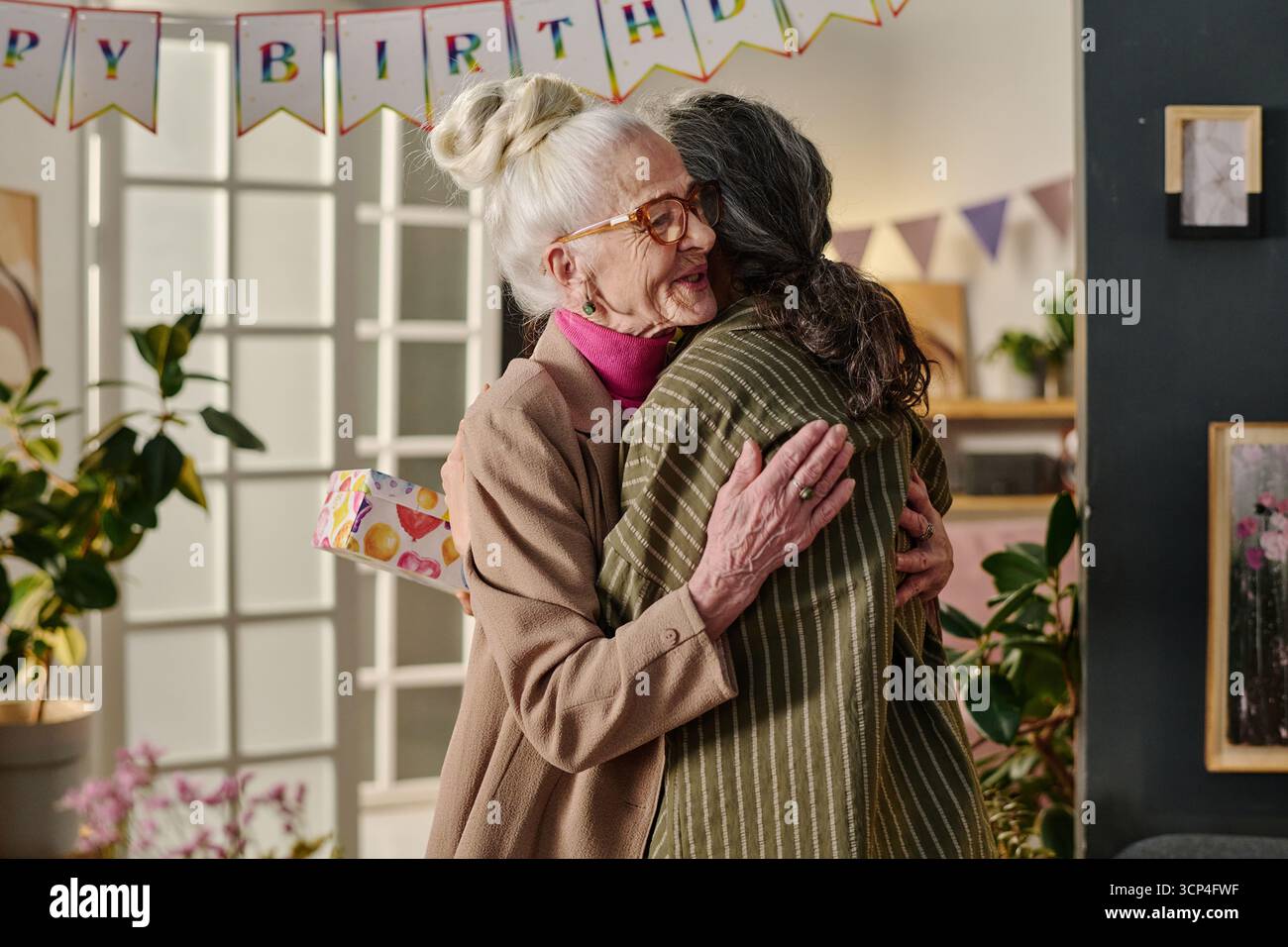 Senior Woman Hugging Middle Aged Woman during Birthday Celebration ...