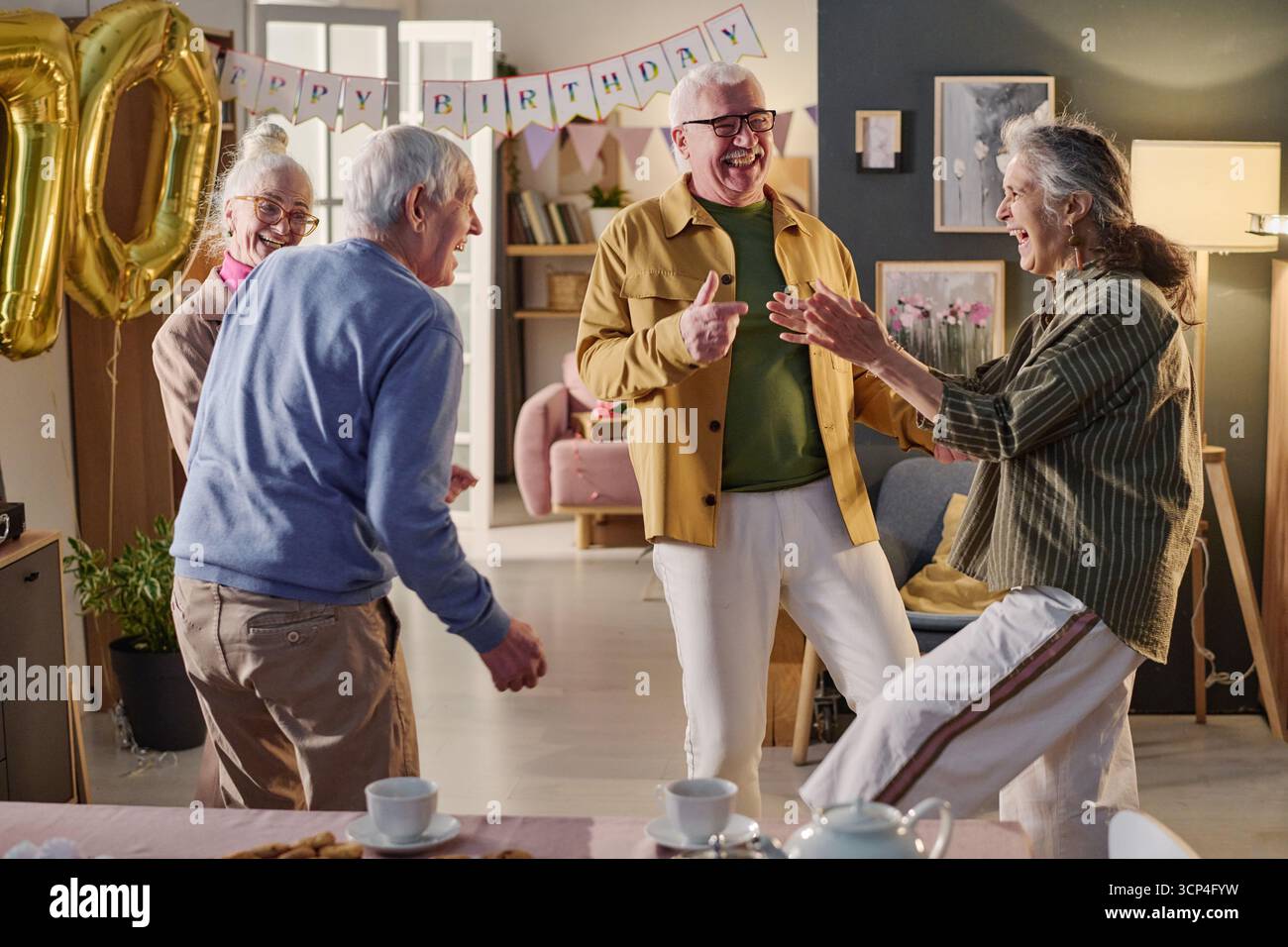 Group of Senior Friends Laughing and Dancing at Birthday Party Stock ...