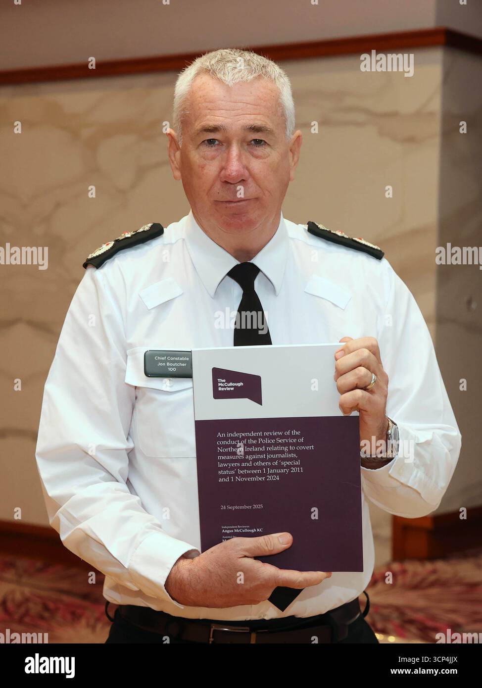PSNI chief constable Jon Boutcher holds a copy of the McCullough Review ...