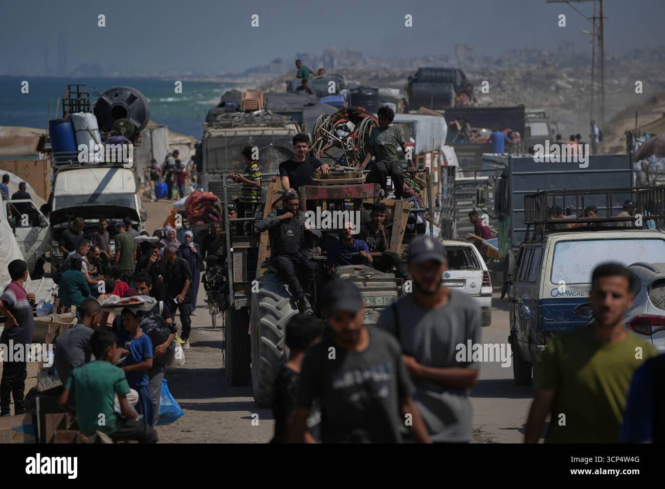 Displaced Palestinians flee northern Gaza Strip as they walk carrying ...