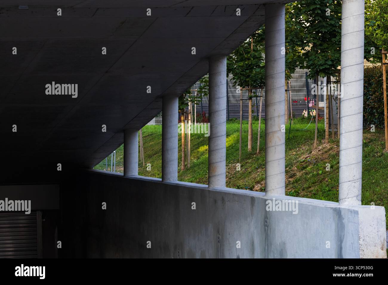 concrete underpass garage doors structure with cylindrical columns ...