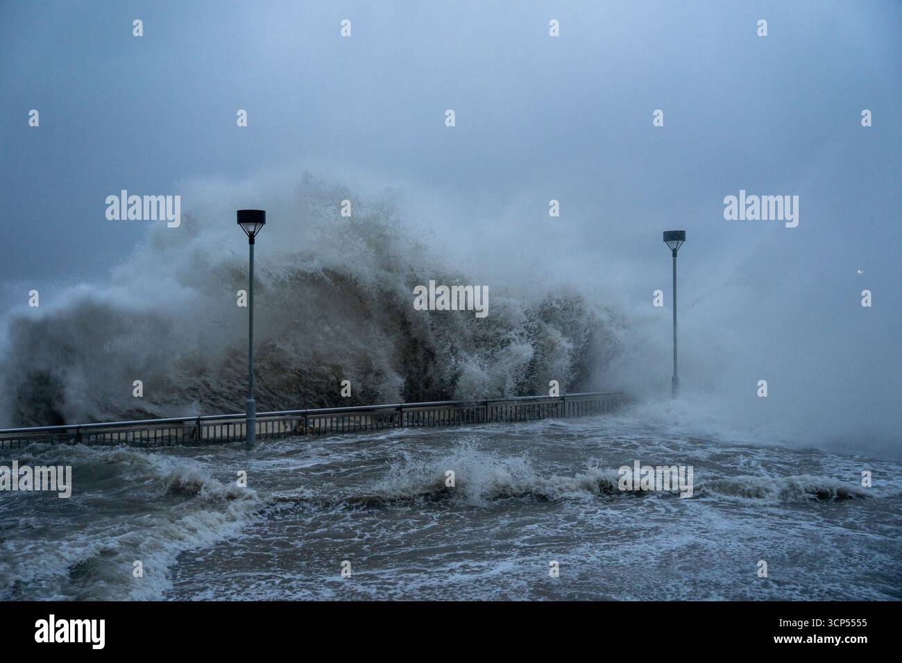 September 24, 2025, Hong Kong, China: Waves splashing onto a promenade ...