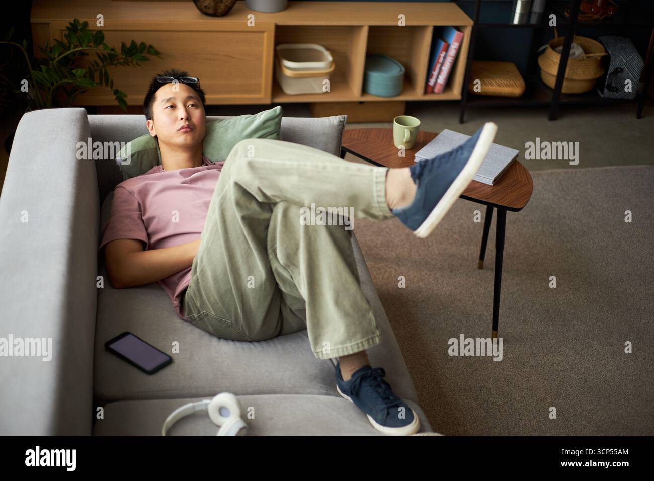 Young man headphones smartphone gazing hi-res stock photography and ...