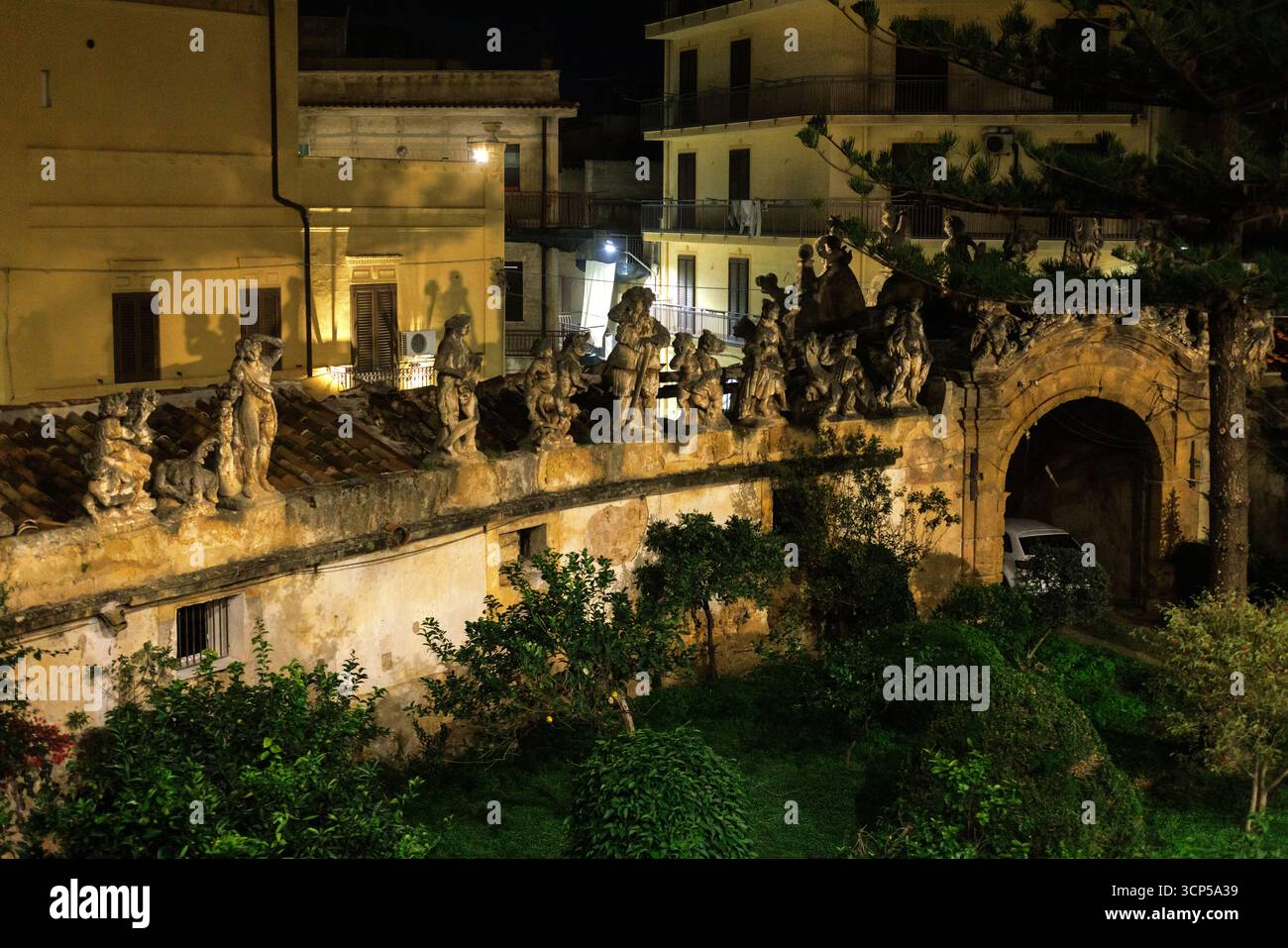 Night view of people and monster sculptures made of tuff in the Villa ...