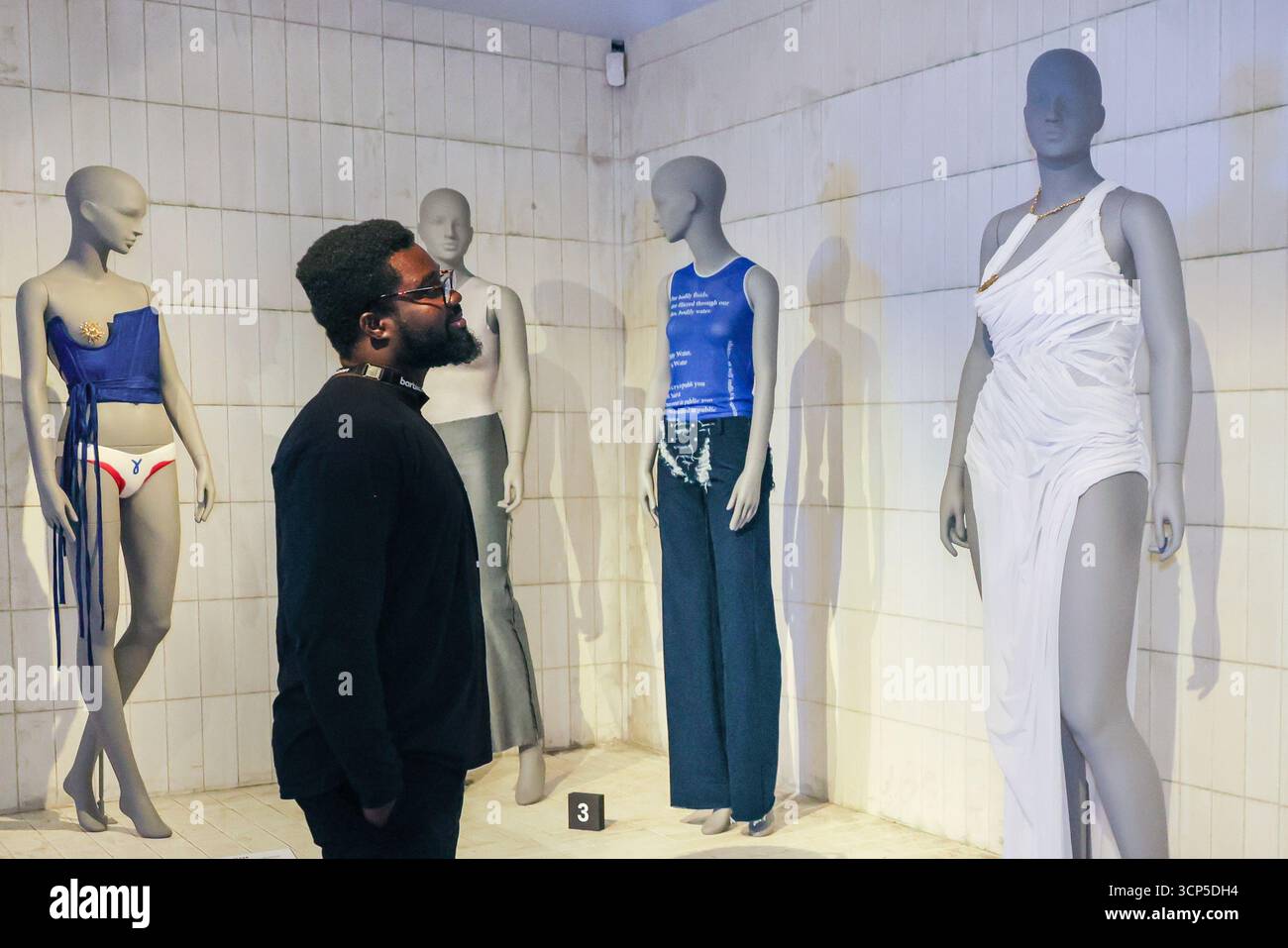 London, UK, 24th Sep 2025. Museum staff with a range of designs in the ...