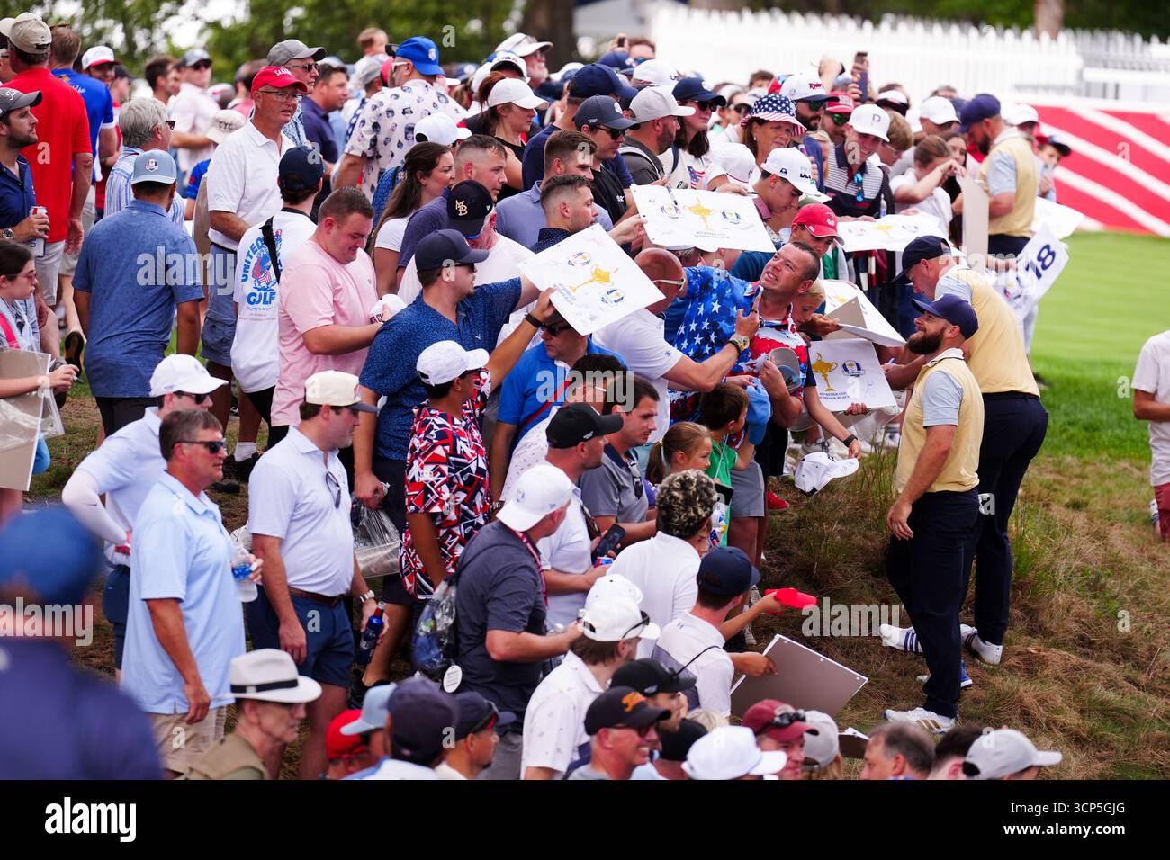 Tyrrell Hatton of Team Europe signs autographs for spectators during a ...