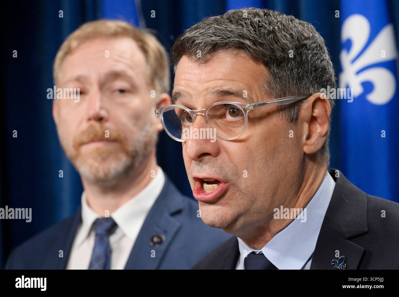 Quebec Conservative Leader Eric Duhaime ,right, speaks at a news ...