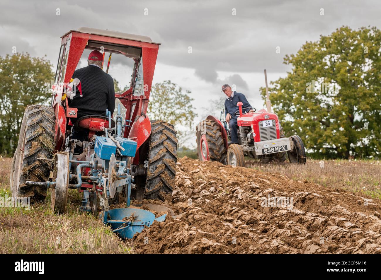 Two 'Class 4 Classic' tractors and ploughs pass each other as they take ...