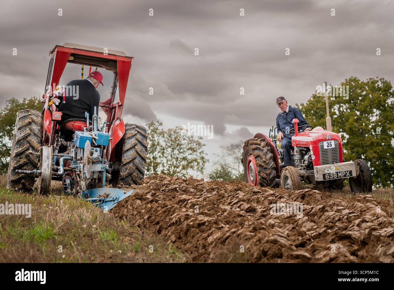 Two 'Class 4 Classic' tractors and ploughs pass each other as they take ...