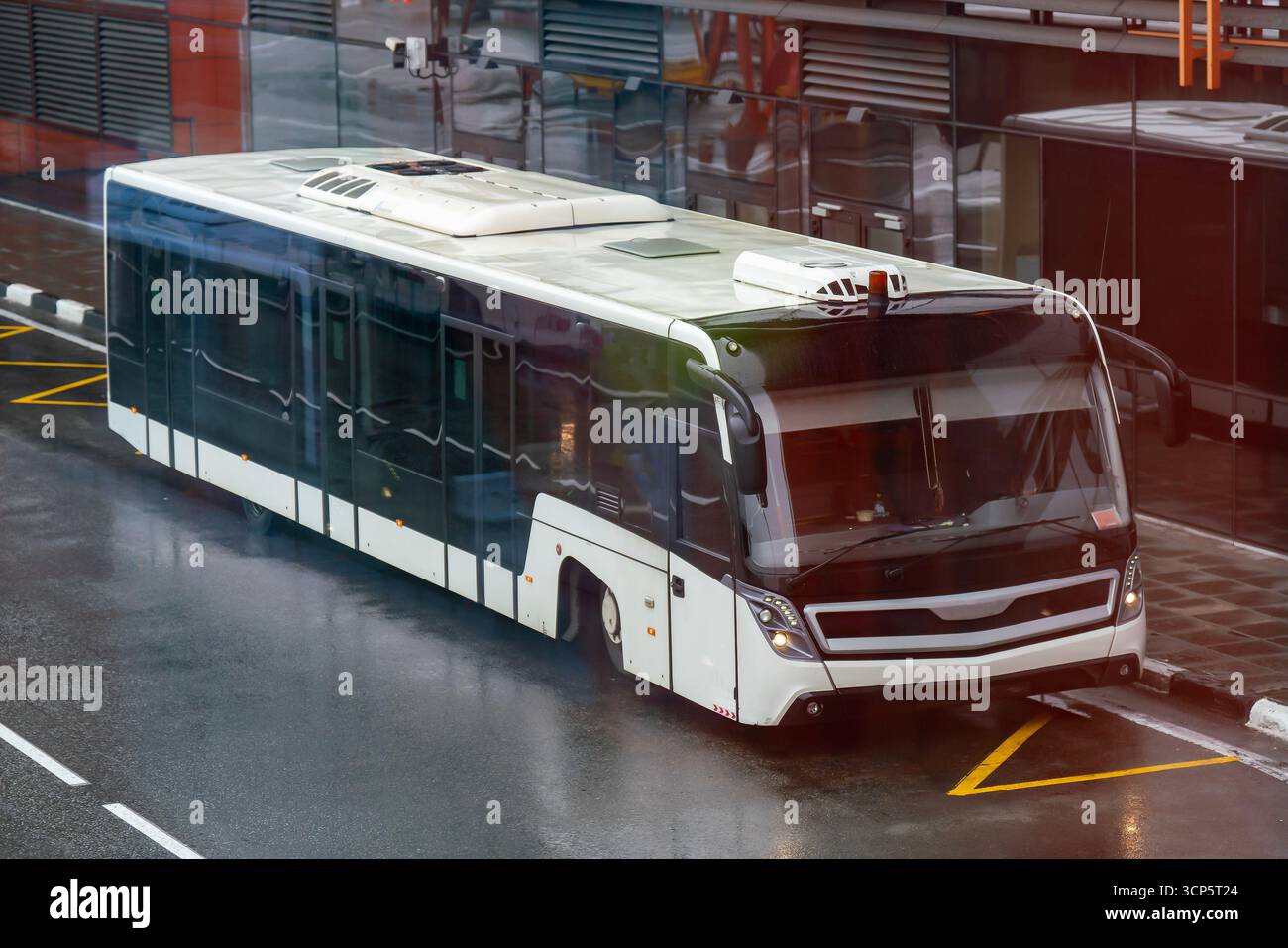 A long bus for transporting passengers to the aircraft steps Stock ...