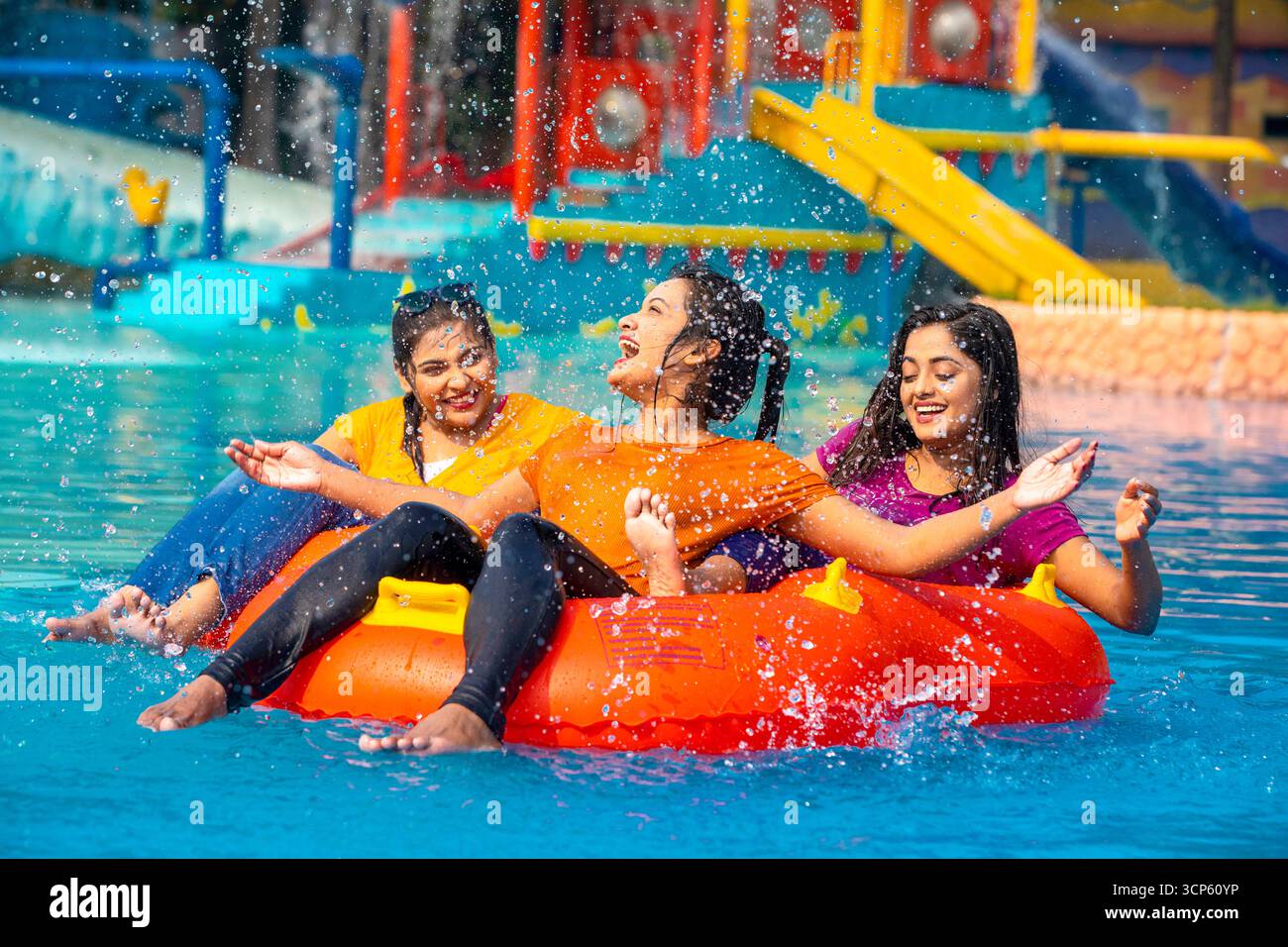 Three happy friends splashing hi-res stock photography and images - Alamy