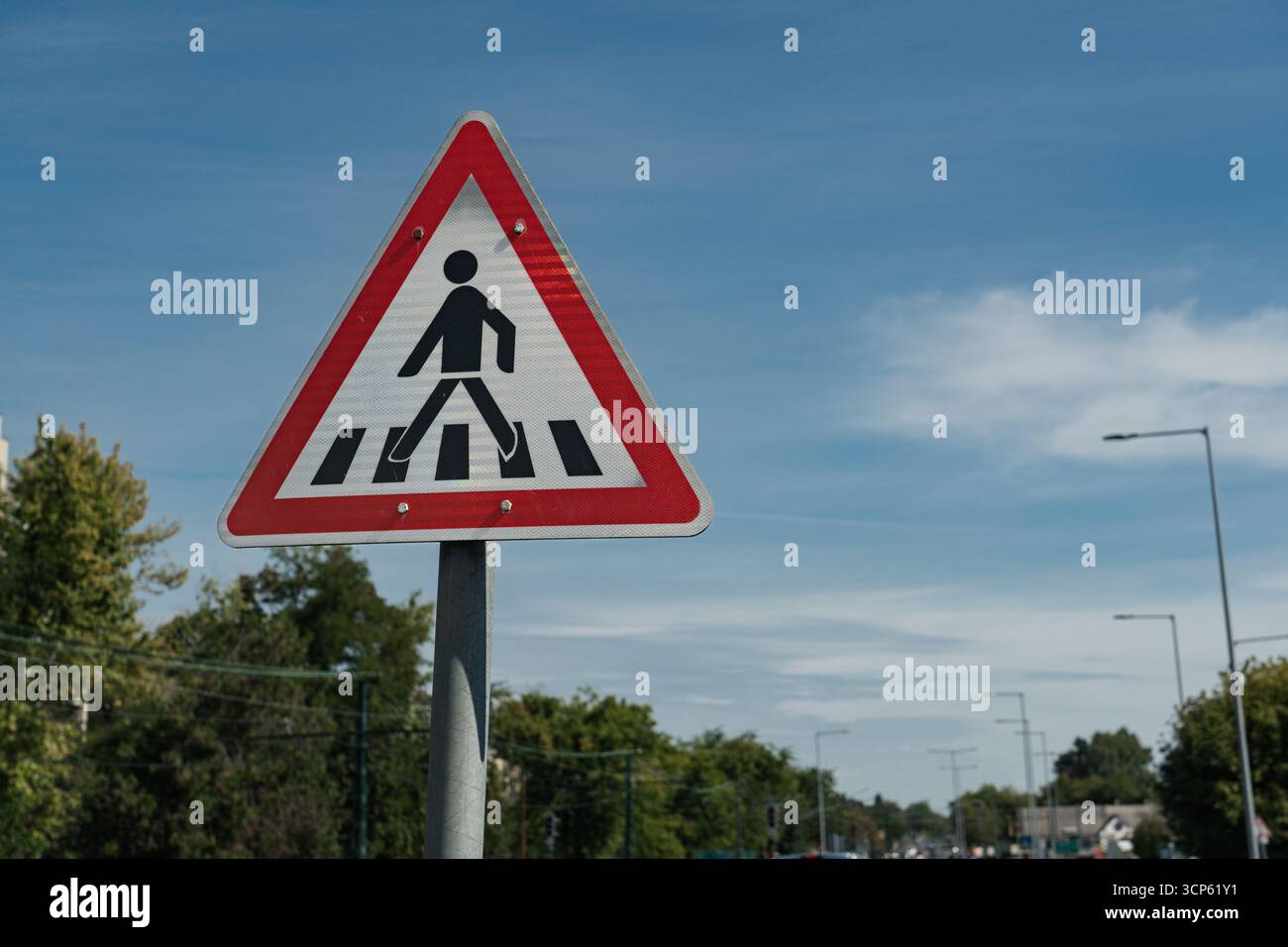 Traffic sign warning drivers of pedestrian crossing under a clear blue ...