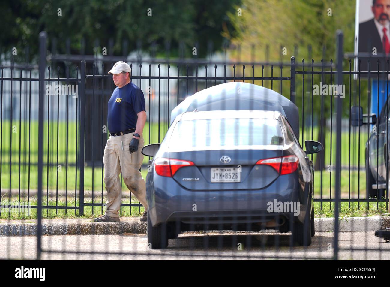 An FBI agent walks near a vehicle near the scene of a shooting at a U.S ...