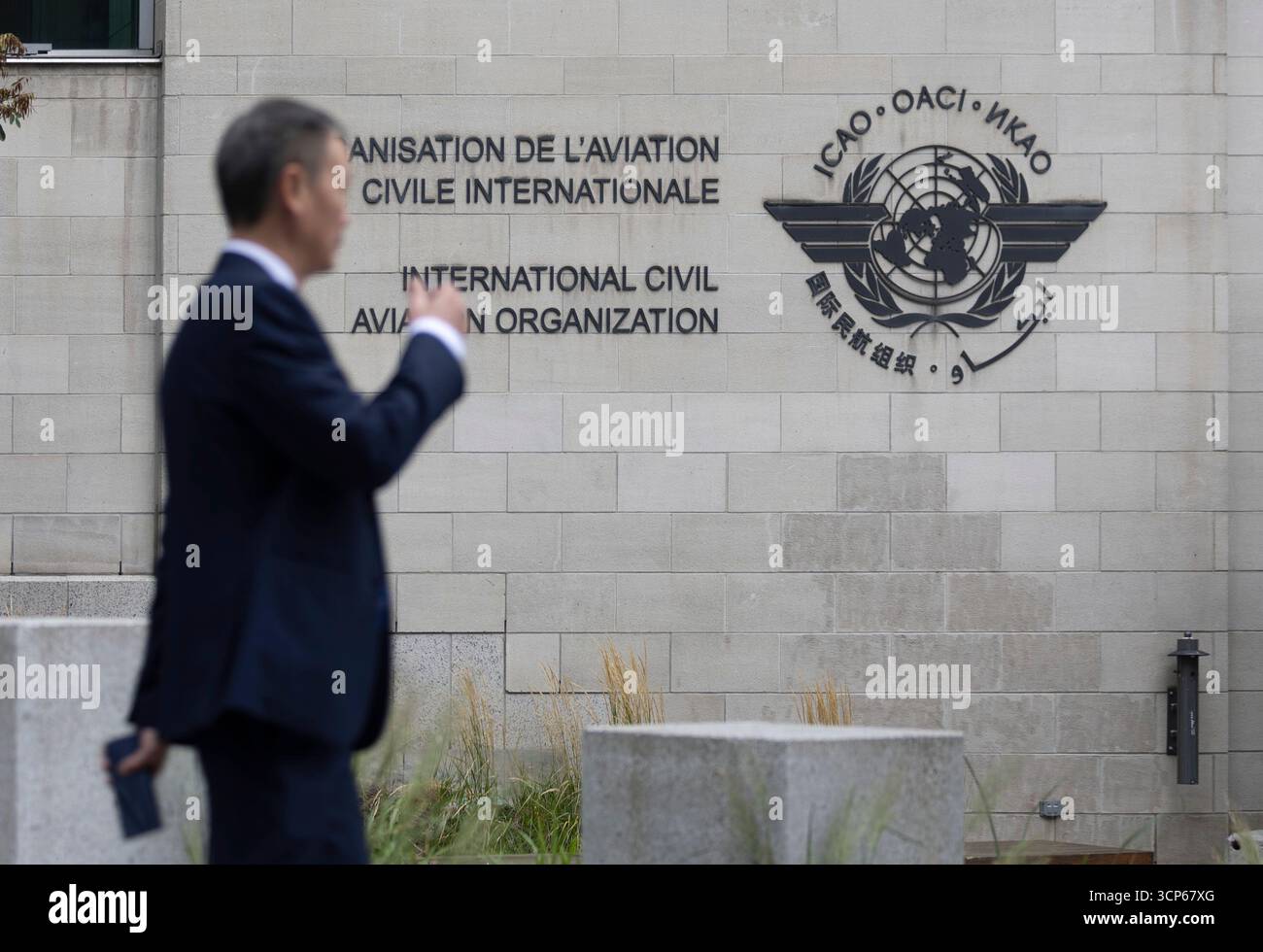 A person walks past the International Civil Aviation Organization (ICAO ...