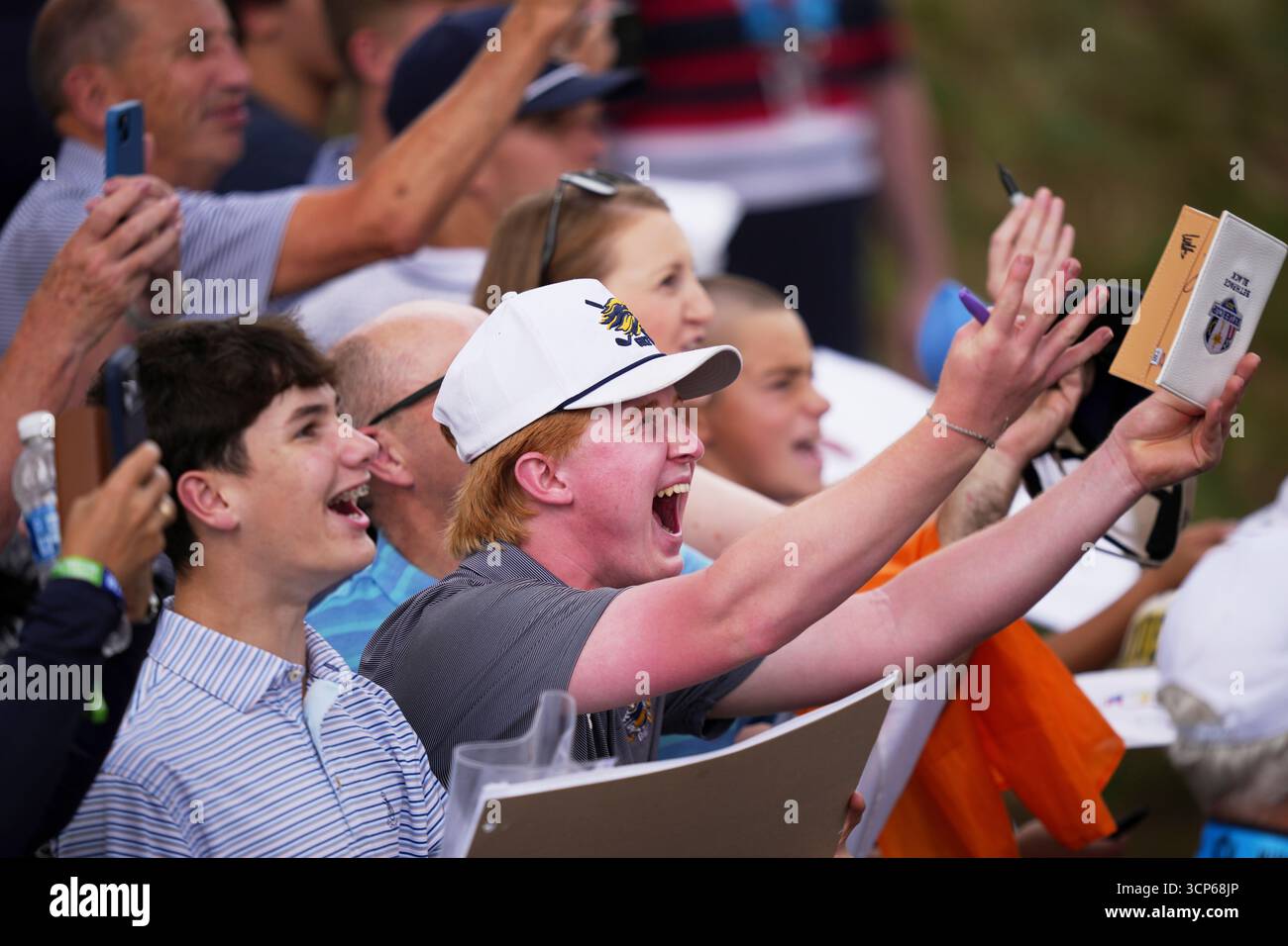 Fans yell on the 13th hole during a practice round for the Ryder Cup ...