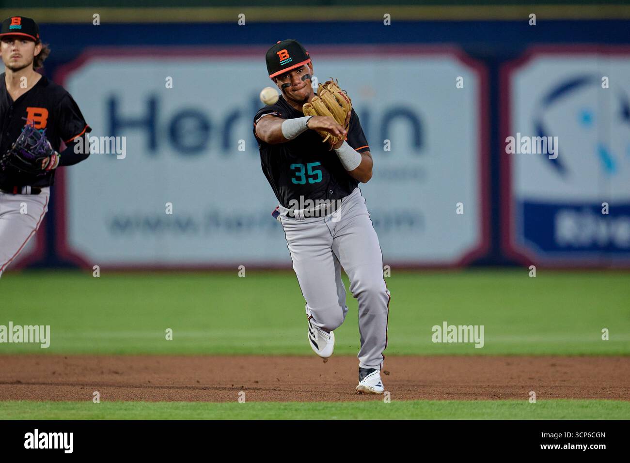 Chesapeake Baysox third baseman Jose Perez (35) throws to first base ...