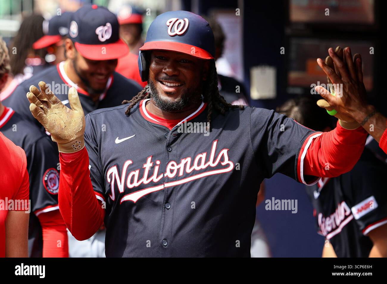 Washington Nationals' Josh Bell high-fives teammates in the dugout ...
