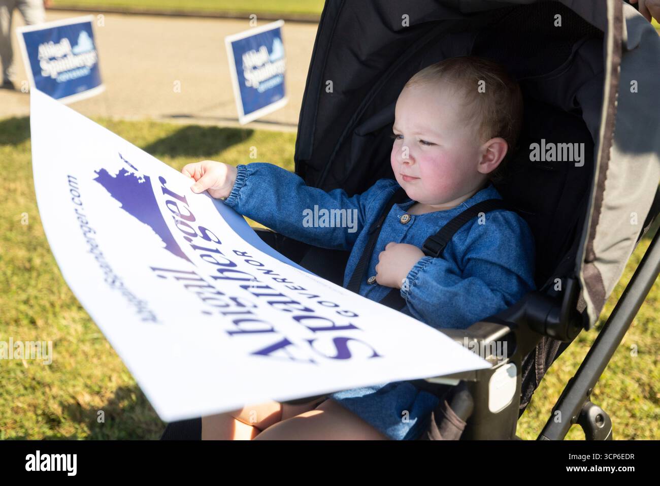 Eliza, 1, holds a sign for Democratic gubernatorial candidate Abigail ...