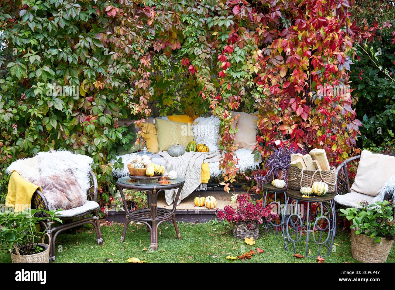 Cozy autumn garden swing decorated with pumpkins, pillows, and blankets ...