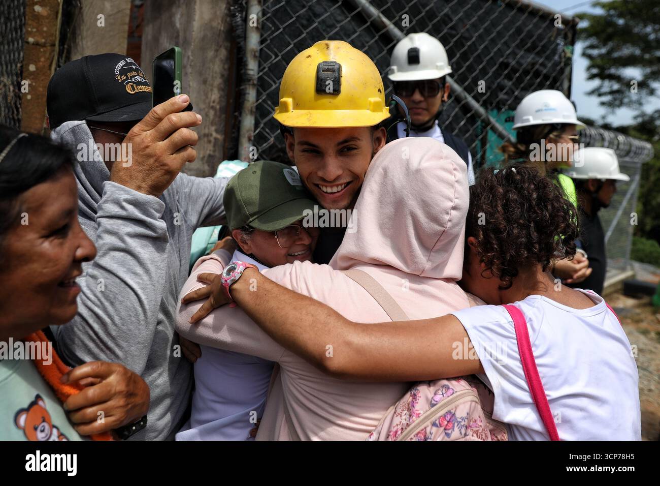 A miner embraces family members after he was rescued from a gold mine ...