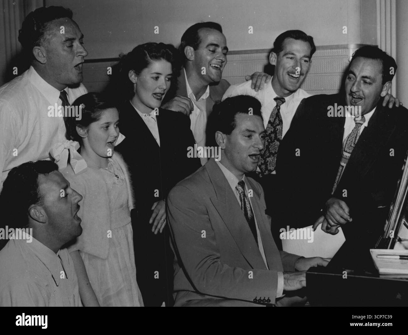 Stars and producer of 2GB's Bunkhouse Show gather around the piano for ...