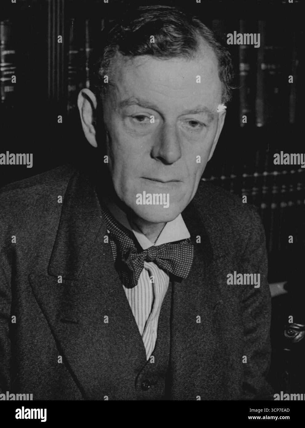 Britain's Chief Prosecutor In Tokyo:Against a background of legal books ...