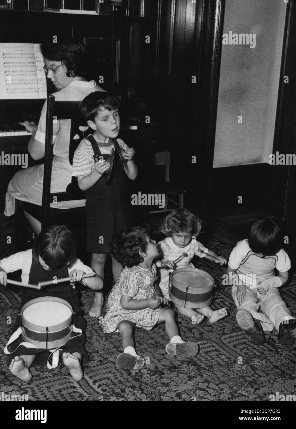 Children playing the cymbals Black and White Stock Photos & Images - Alamy