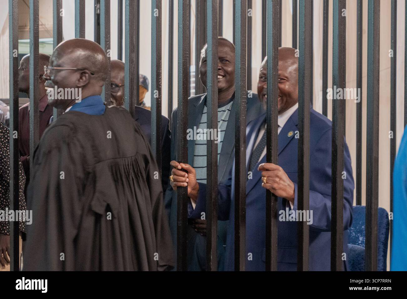South Sudan's suspended First Vice President Riek Machar, right, gestures in the dock with seven ...