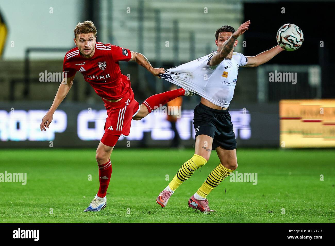 Eupen's Igor Plastun and Lokeren's Robbie Van Hauter fight for the ball ...