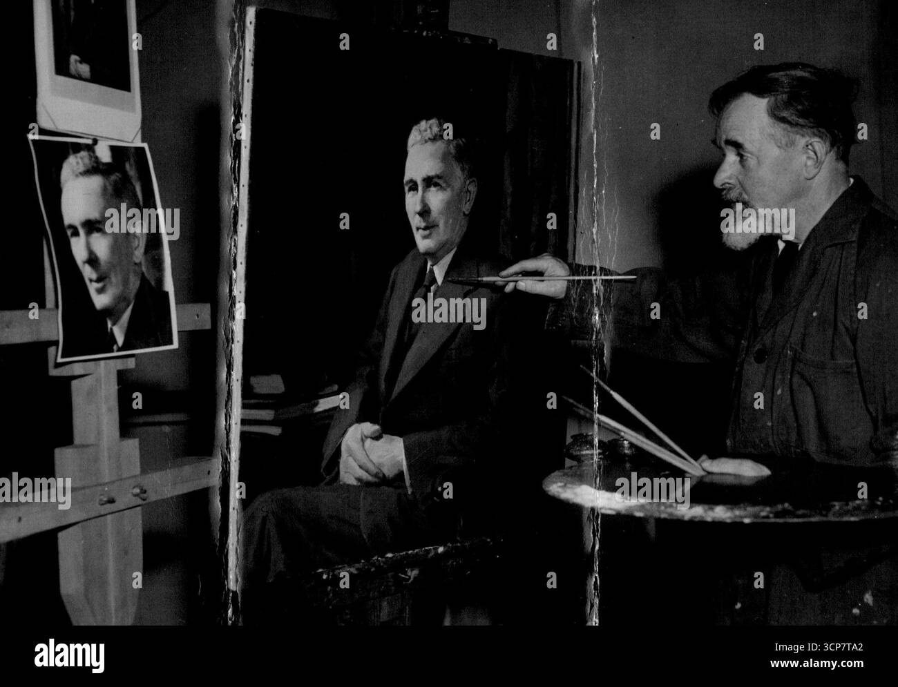Artist Mr A. Colquhoun puts the ***** touches to his portrait of Mr J ...